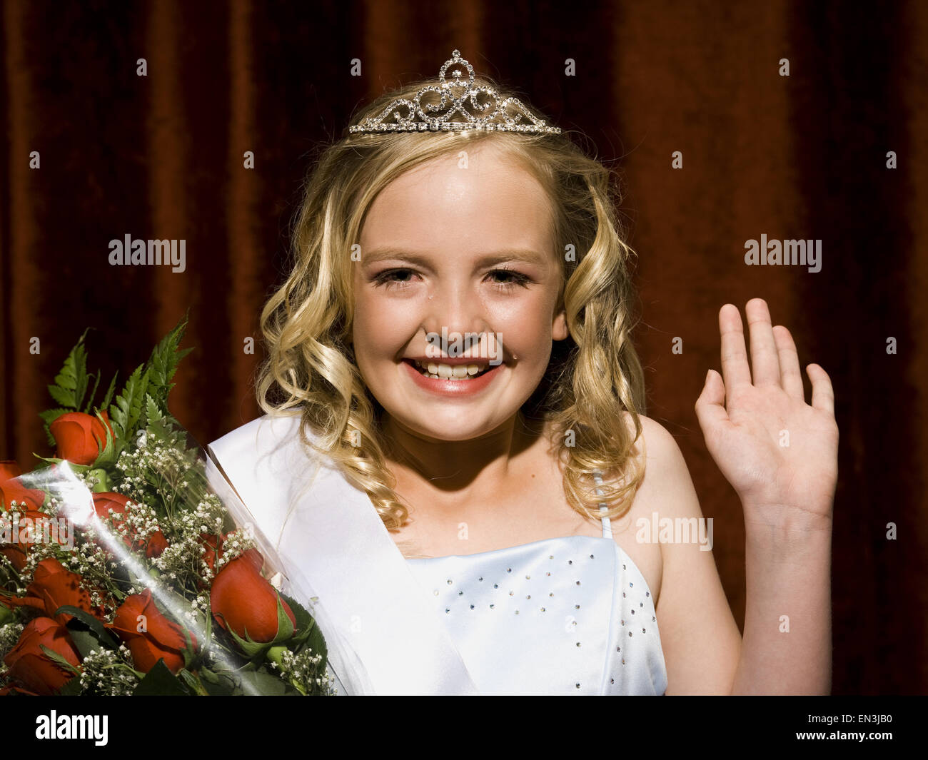 Beauty pageant winner smiling and holding roses Stock Photo - Alamy