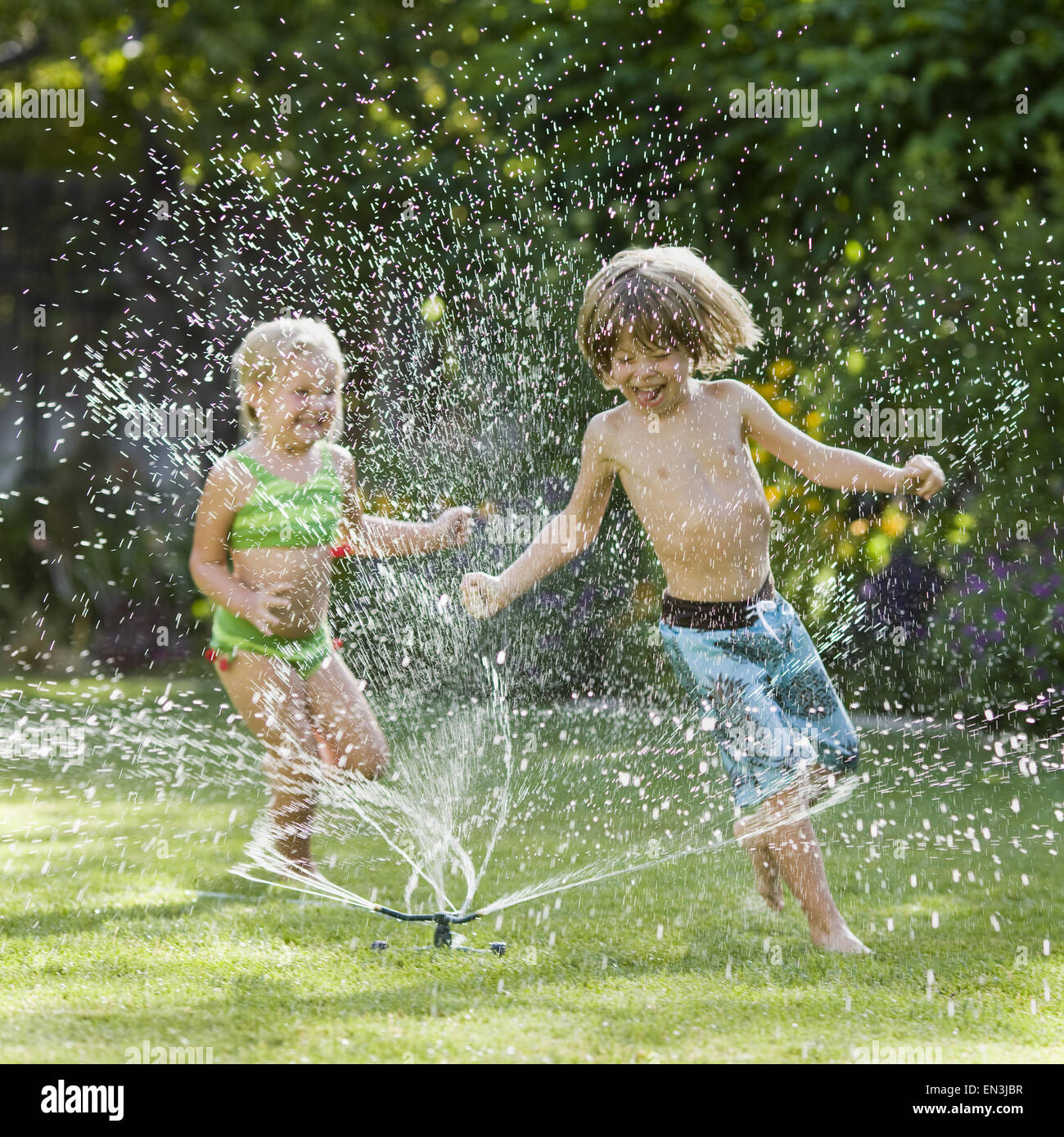 children playing in a sprinkler Stock Photo - Alamy