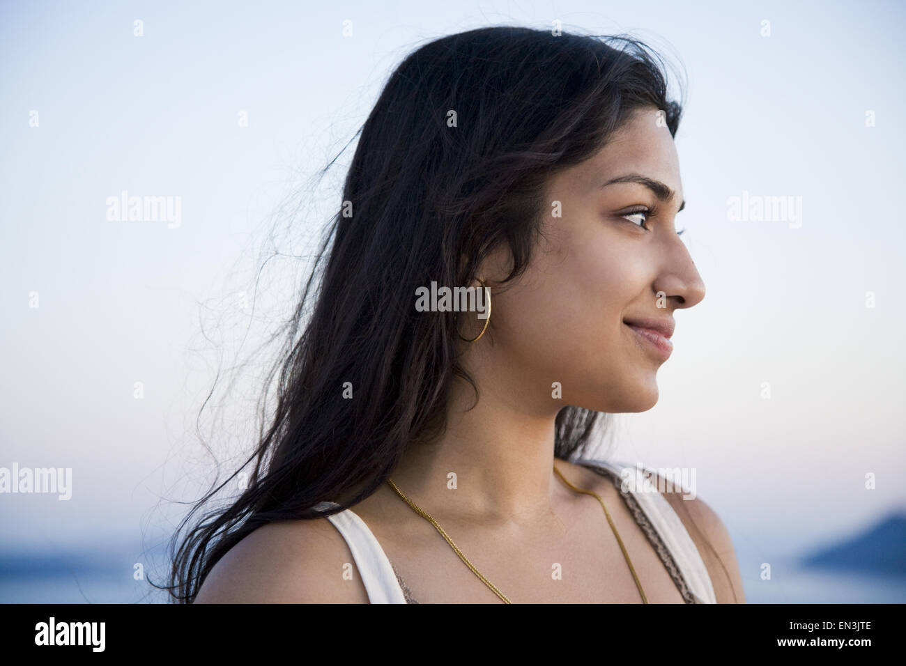 Profile of woman outdoors smiling Stock Photo - Alamy