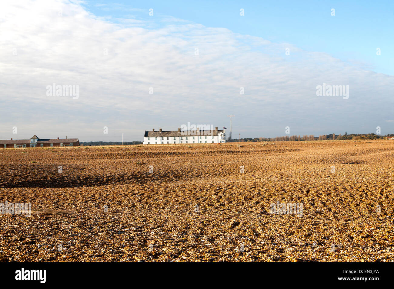 Frontal clouds passing over Coastguard Cottages shingle beach at ...