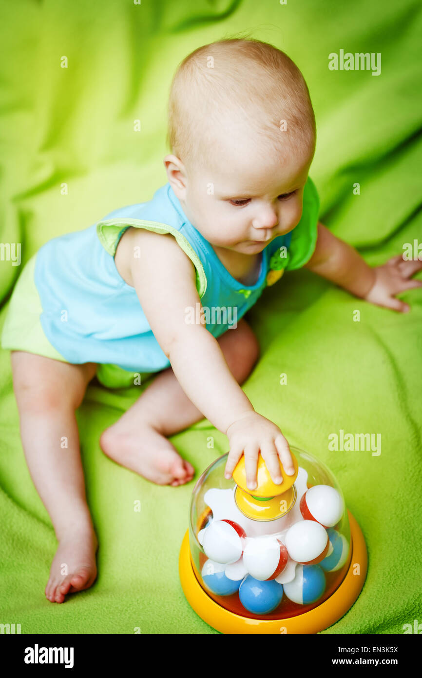 Adorable little baby playing with educational toys. One or two years ...