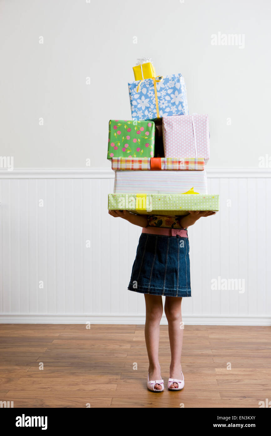 birthday girl carrying a stack of presents Stock Photo - Alamy