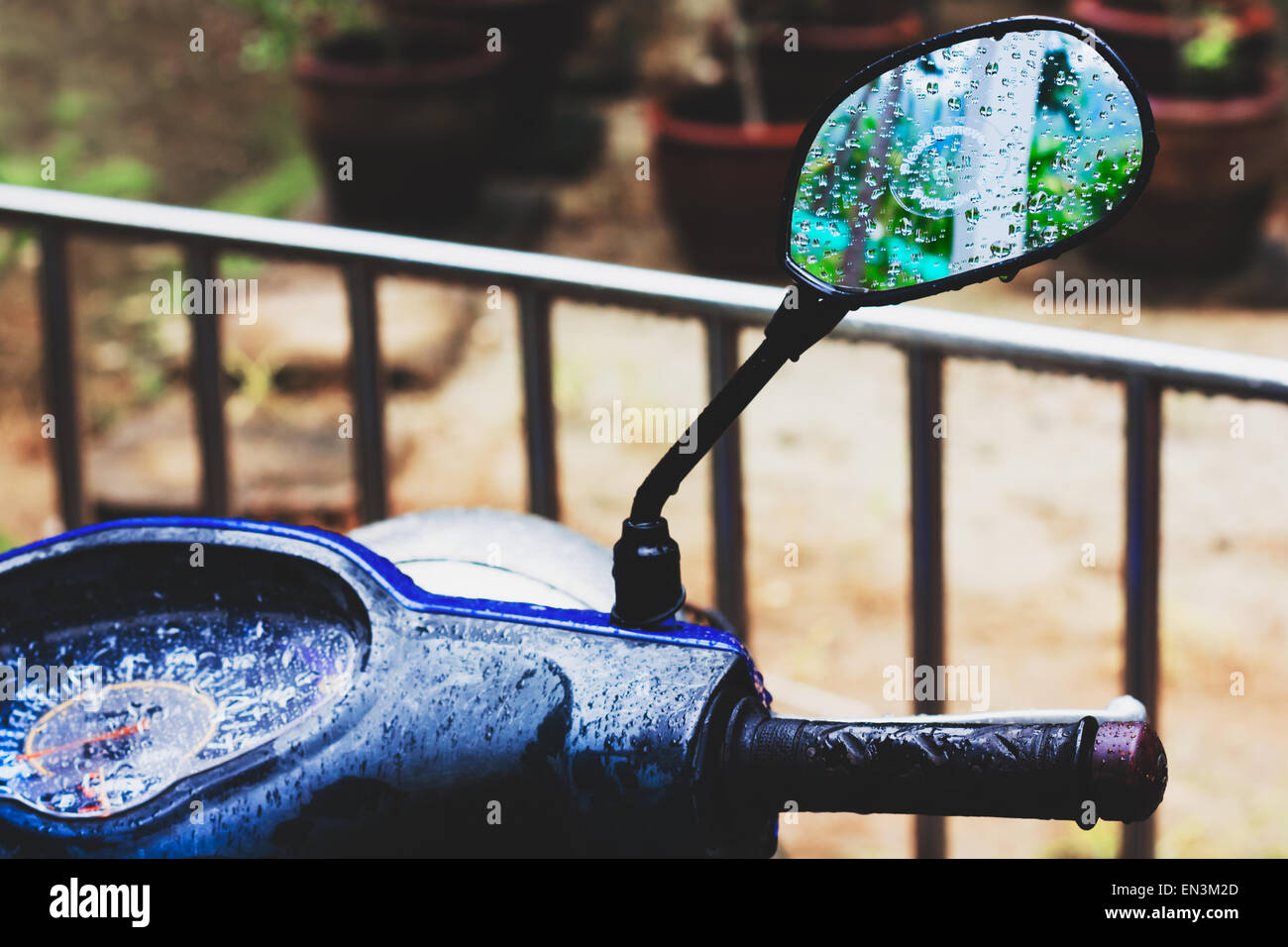 Tropical rain. Mirror of motorbike. Water drops Stock Photo - Alamy