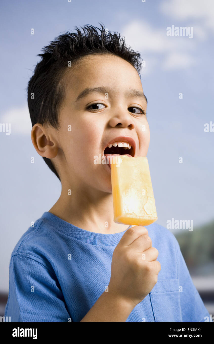 Boy eating popsicle hi-res stock photography and images - Alamy