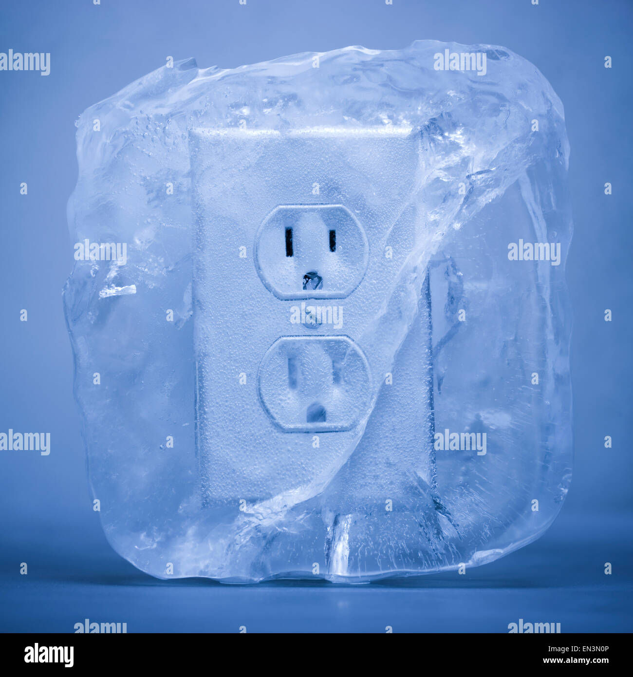 electrical outlet frozen in a block of ice Stock Photo - Alamy