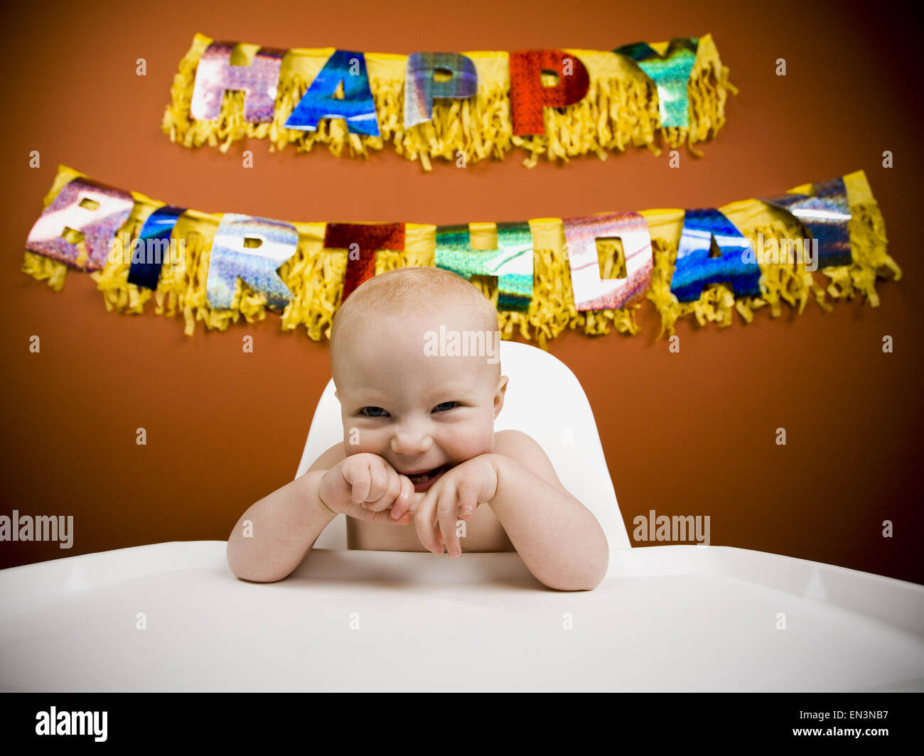 Baby sitting with happy birthday sign in background Stock Photo - Alamy