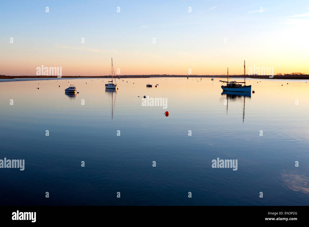 Boats at moorings at sunset on the River Deben, Ramsholt, Suffolk ...