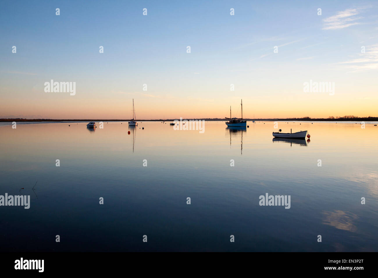 Boats at moorings at sunset on the River Deben, Ramsholt, Suffolk ...