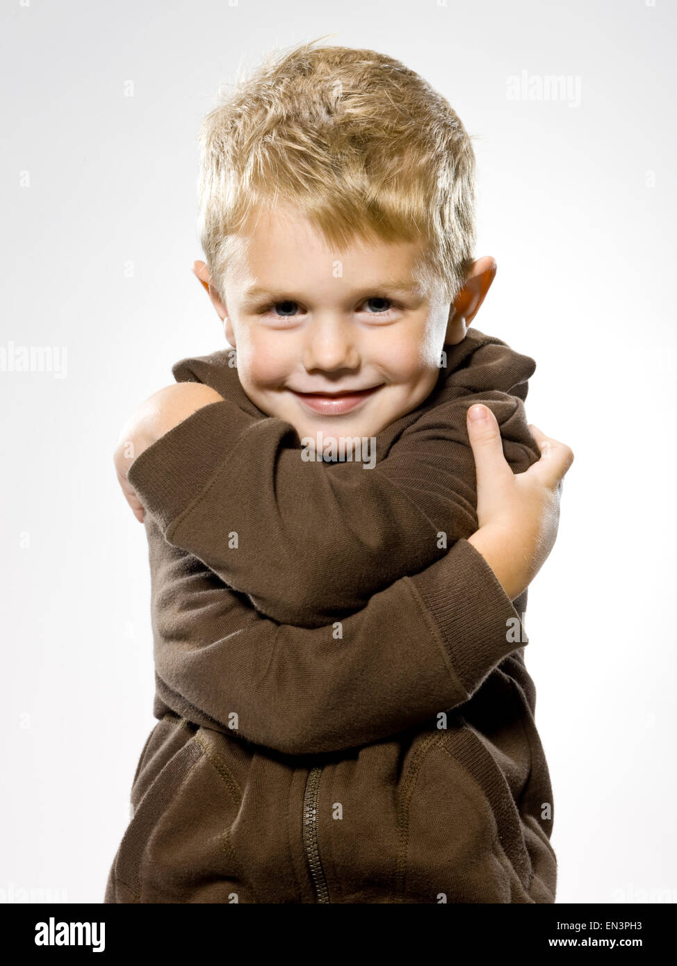 boy hugging himself Stock Photo - Alamy
