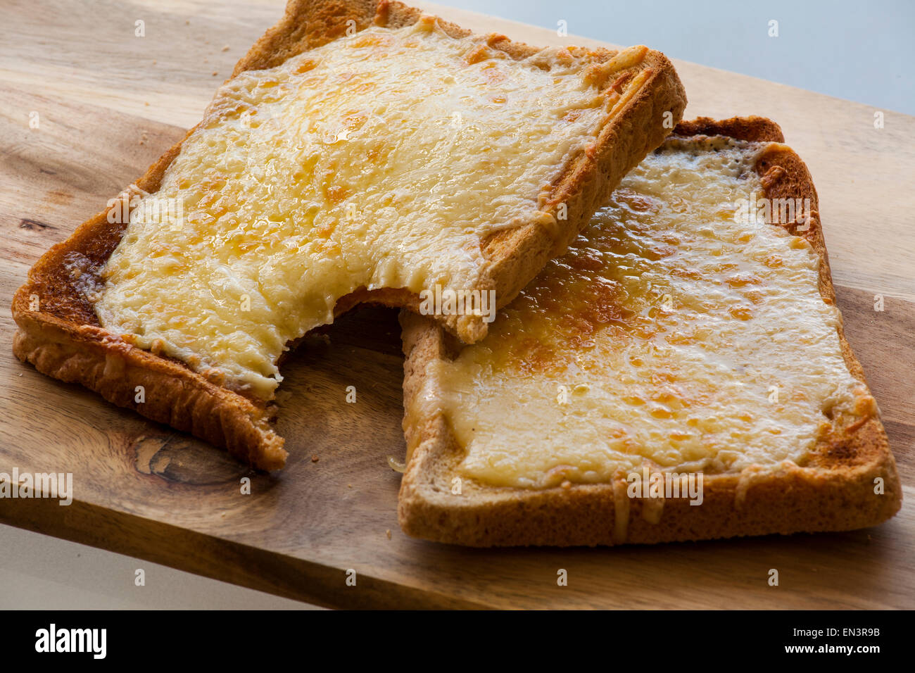 Cheese on toast with a bite taken out of it Stock Photo - Alamy