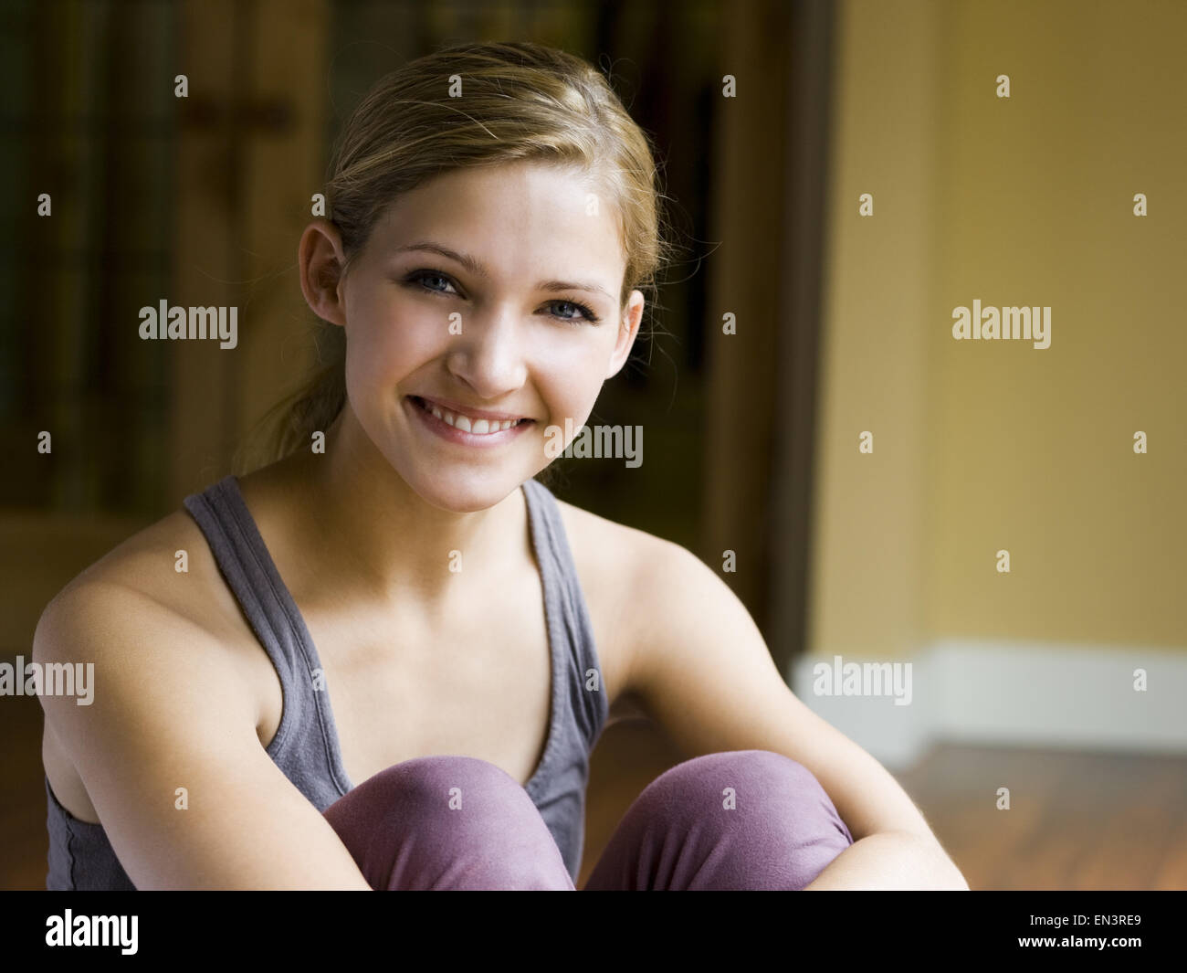 Woman sitting and smiling Stock Photo - Alamy