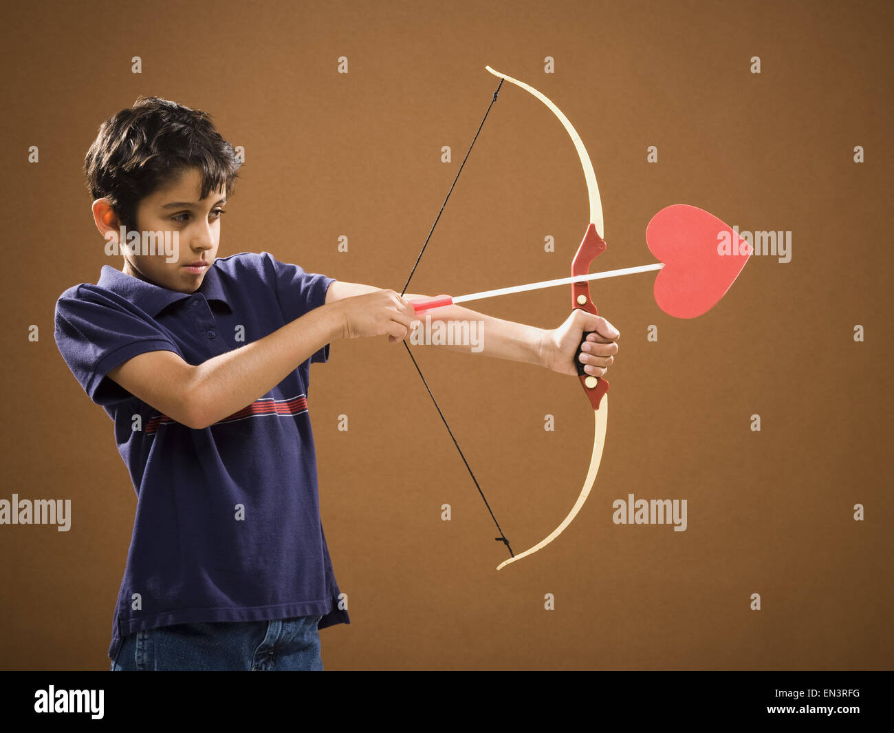 Boy with bow and arrow with heart on it Stock Photo - Alamy