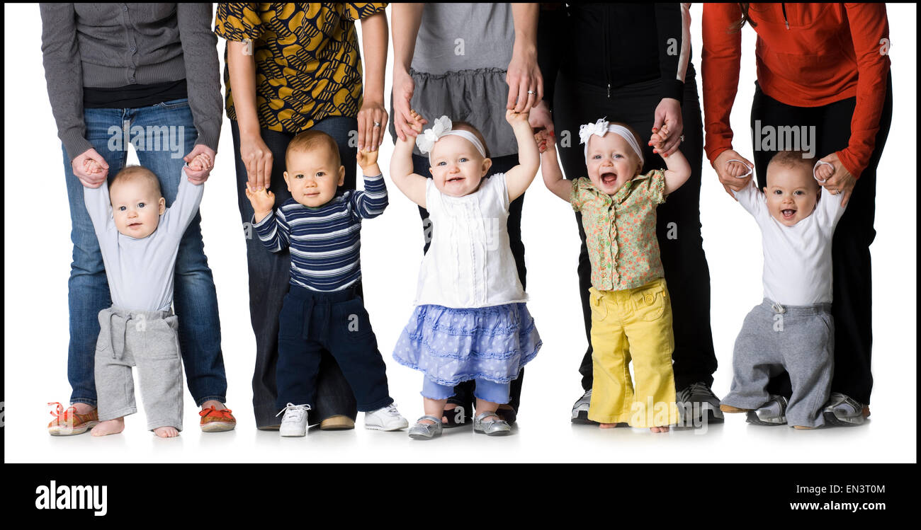 five babies standing Stock Photo - Alamy