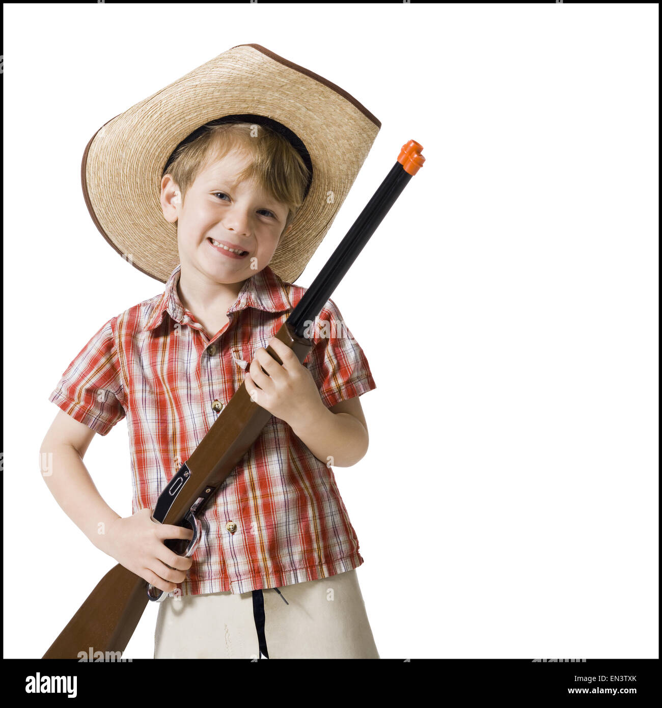 Boy with toy rifle and cowboy hat Stock Photo - Alamy