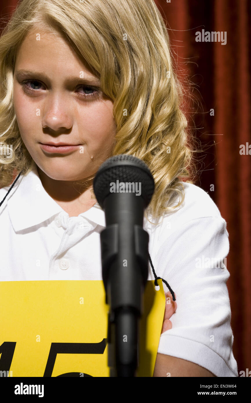 Girl contestant standing at microphone crying Stock Photo - Alamy
