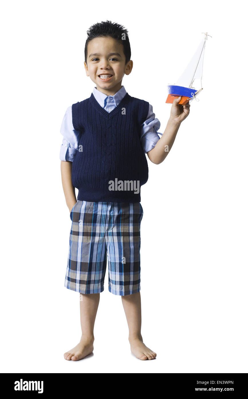 Boy holding toy boat Stock Photo - Alamy