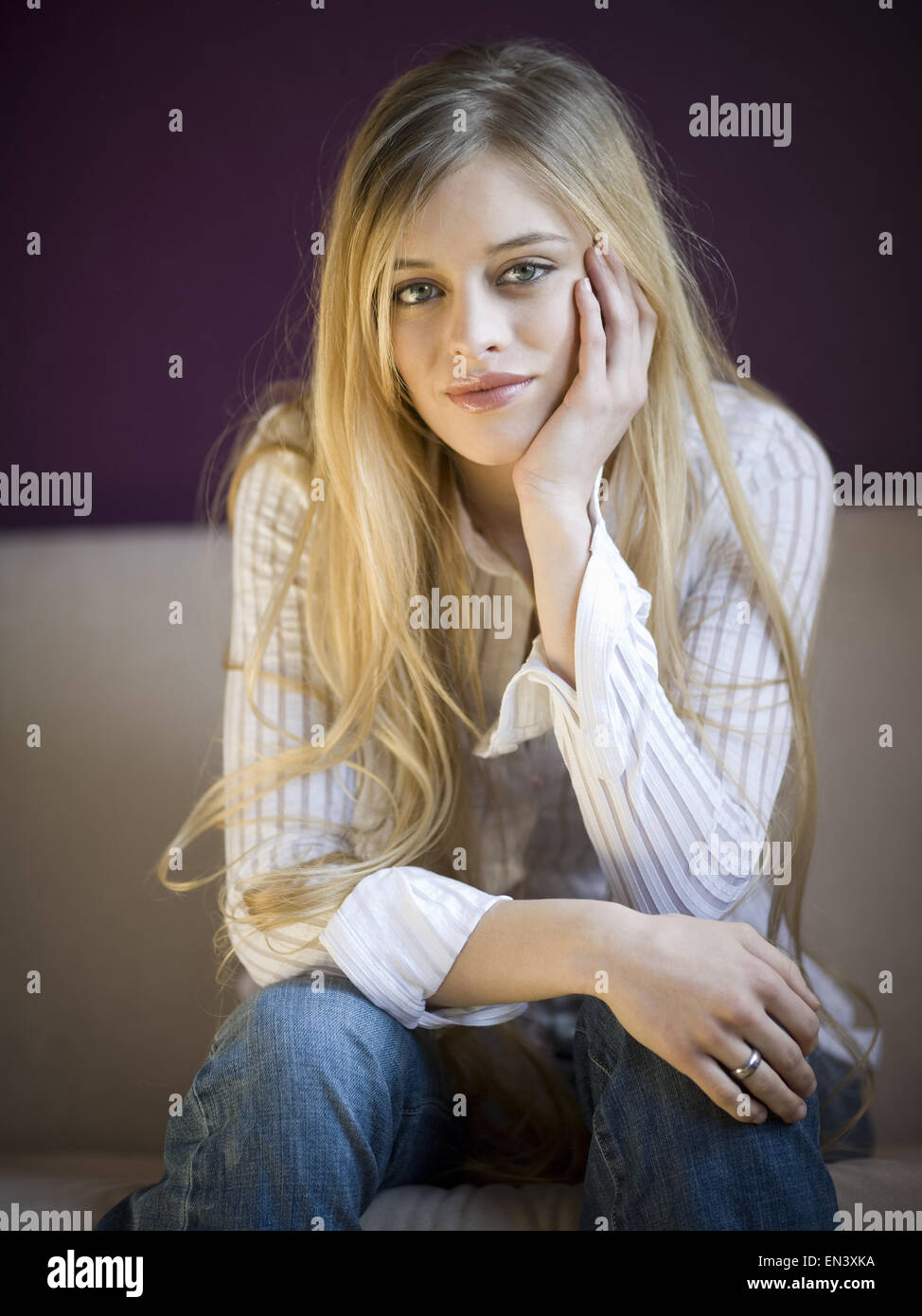 Woman sitting and smiling Stock Photo - Alamy