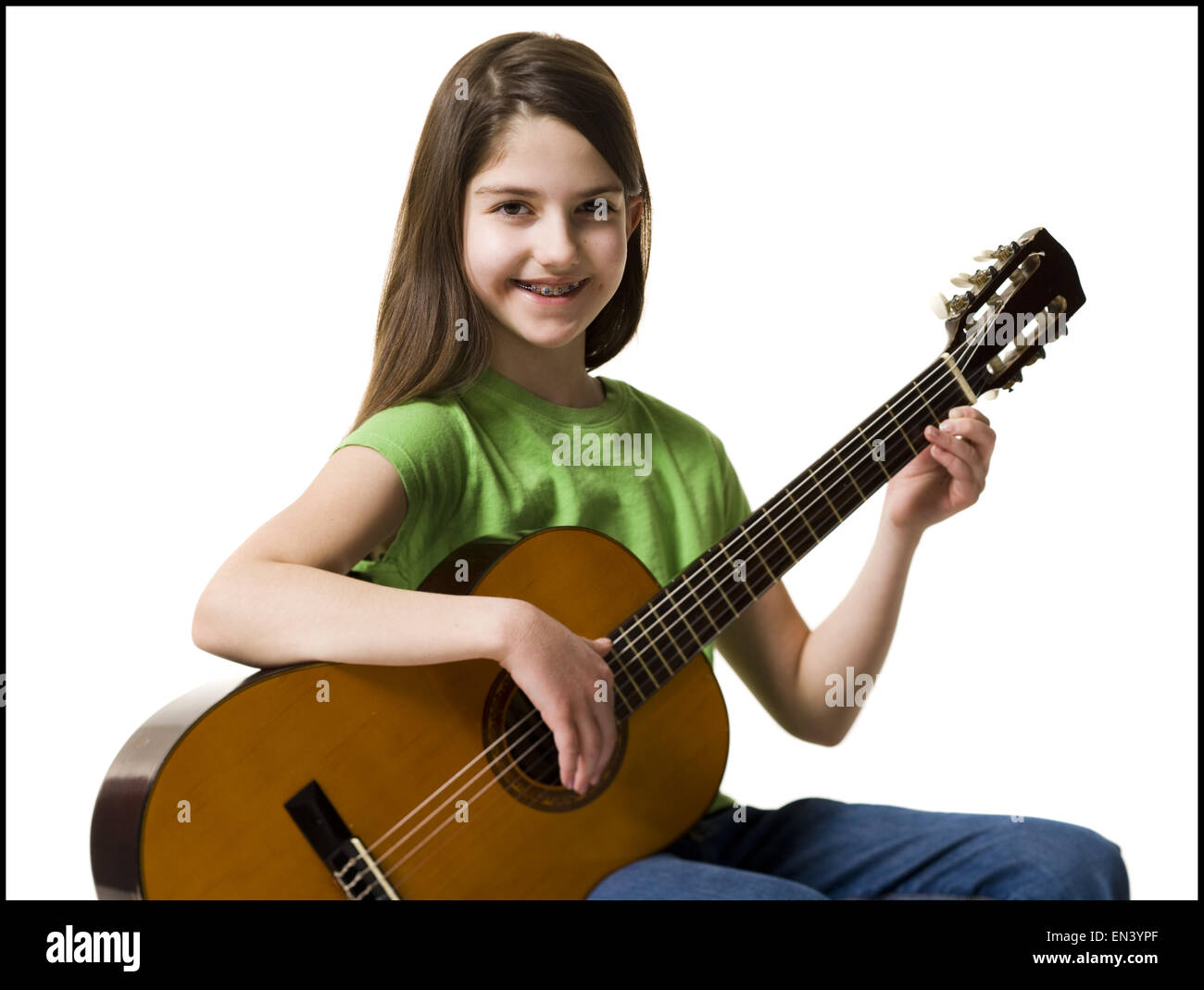 Girl with braces playing guitar smiling Stock Photo - Alamy