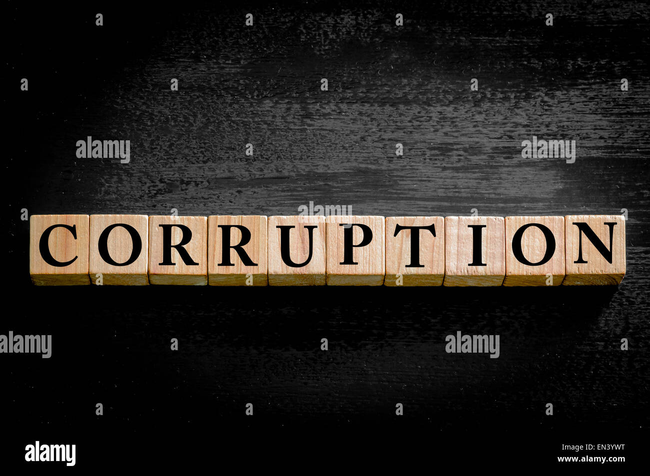 Word CORRUPTION. Wooden small cubes with letters isolated on black ...