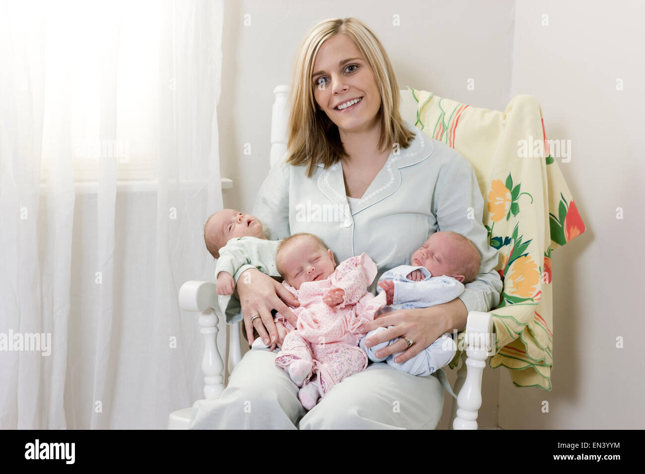 mother with newborn triplets Stock Photo - Alamy
