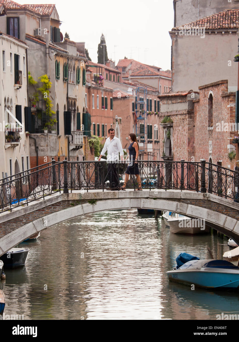 Italy, Venice, Romantic couple walking on footbridge over canal Stock ...