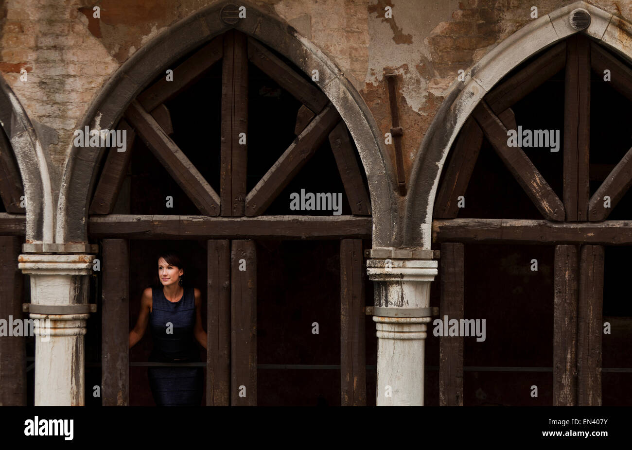Italy, Venice, Woman standing in arcade Stock Photo - Alamy