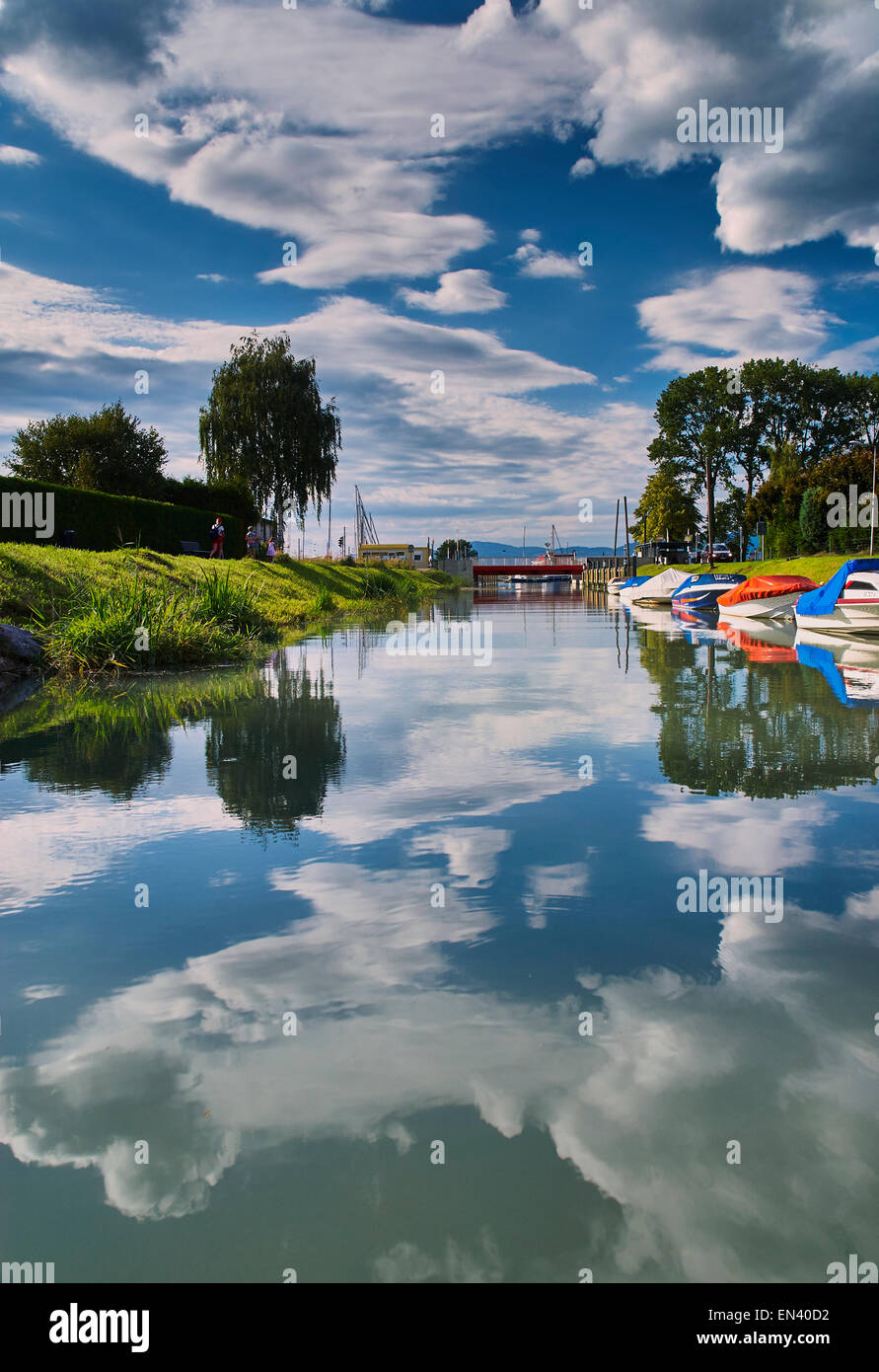 Clouds reflecting in the water in a marina in Le Bouveret on Lake ...