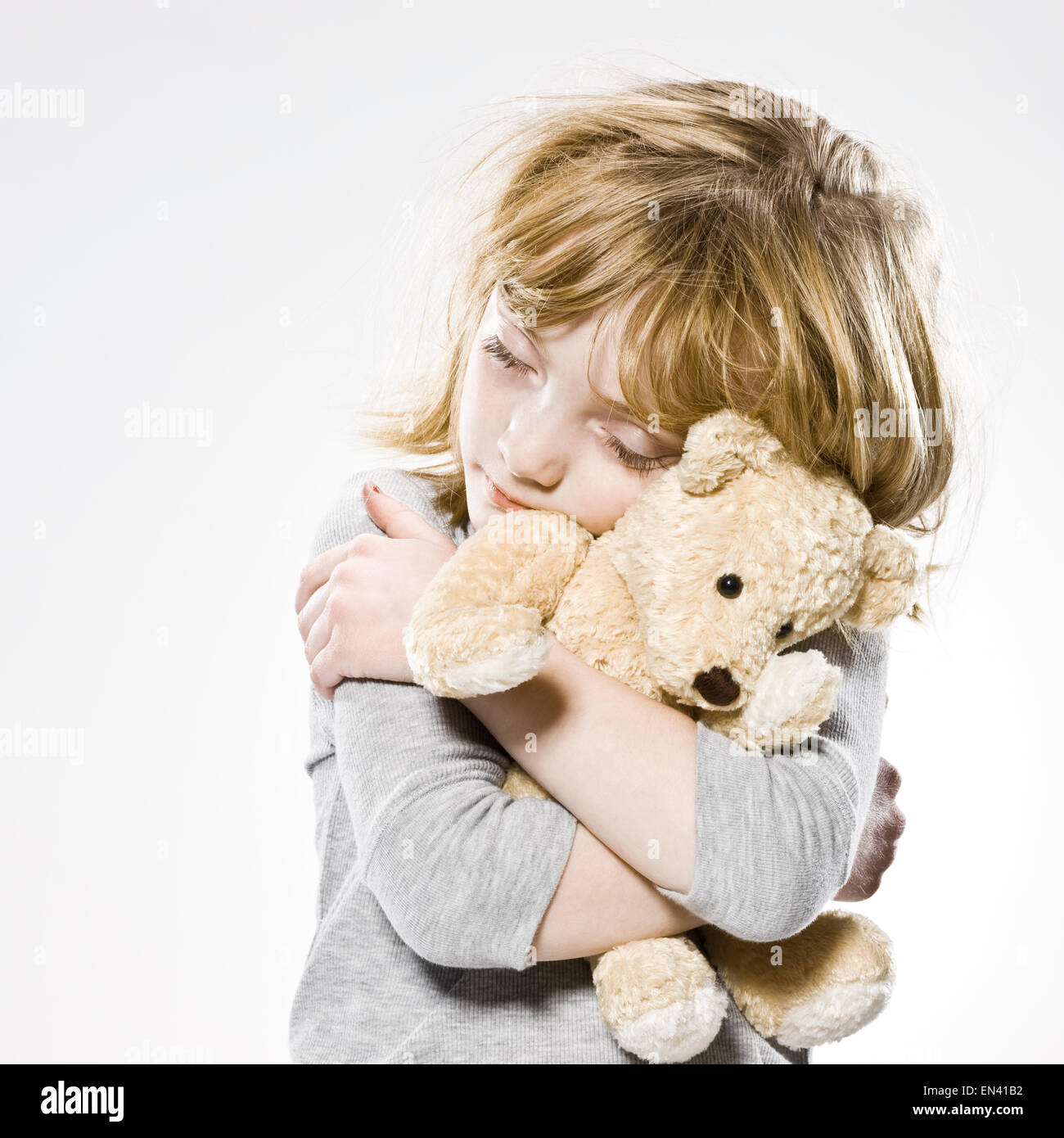 girl hugging her teddy bear Stock Photo - Alamy