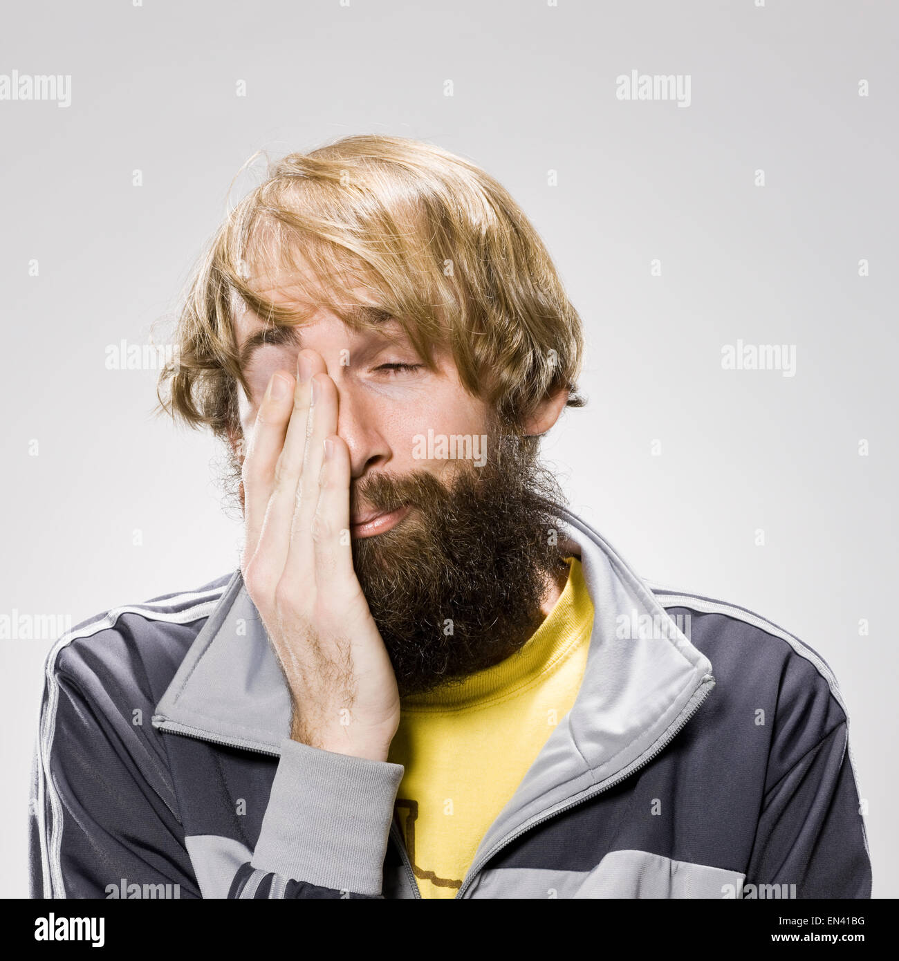 man with a beard wearing a track jacket Stock Photo - Alamy