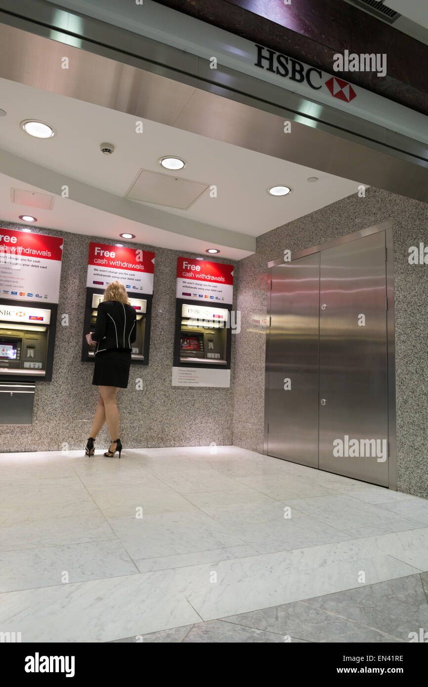 Female using an HSBC ATM machine in Canary Wharf London UK Stock Photo ...