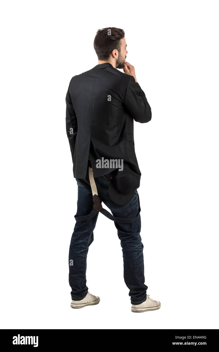 Backside view of young artist looking at blank white wall. Full body ...