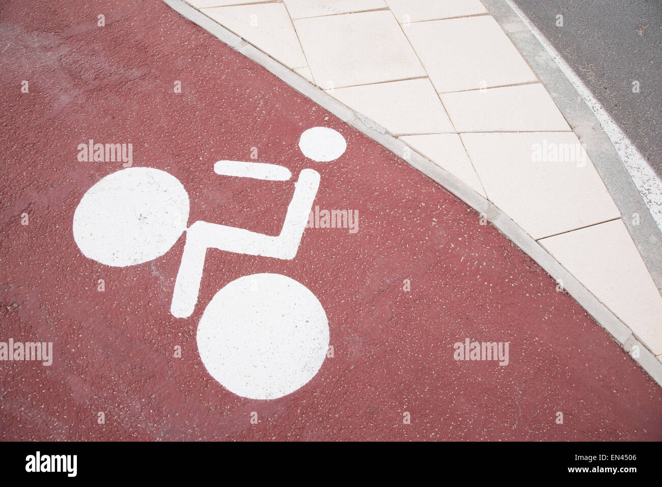 White Bike Lane Symbol in Urban Setting Stock Photo - Alamy