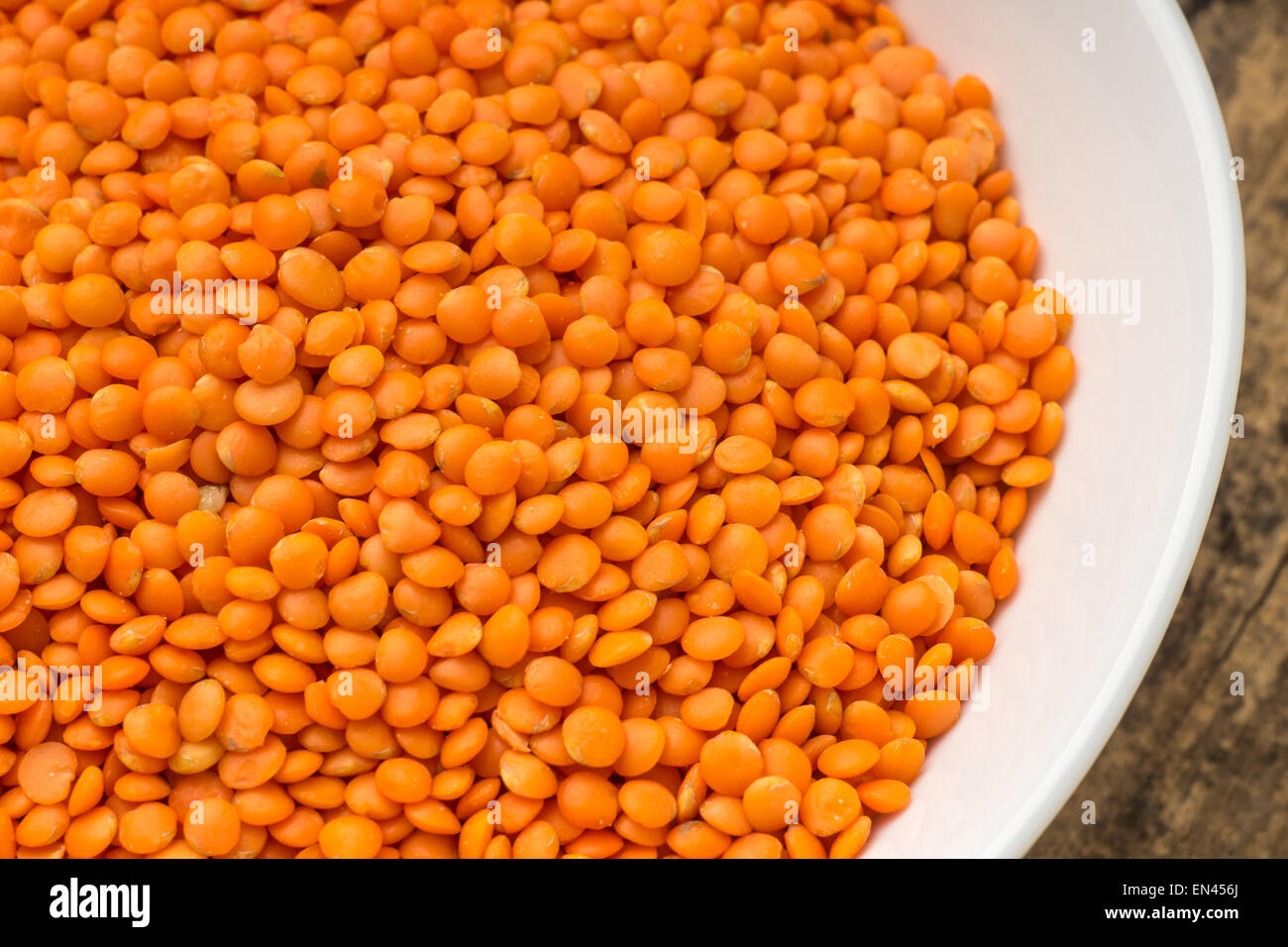 Raw orange lentil in white bowl. Vegetarian food background Stock Photo ...