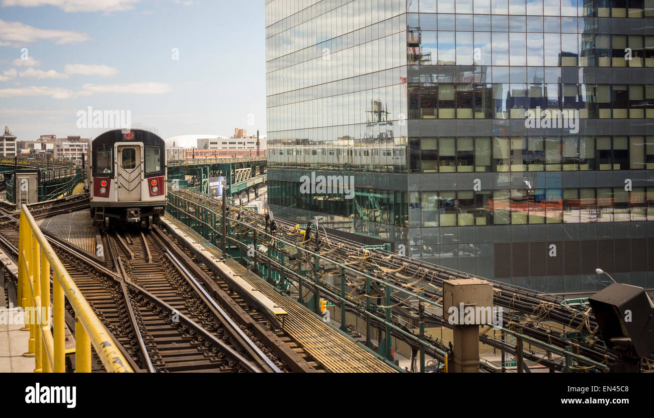A Flushing Line elevated subway train departs Queensboro Plaza, past ...