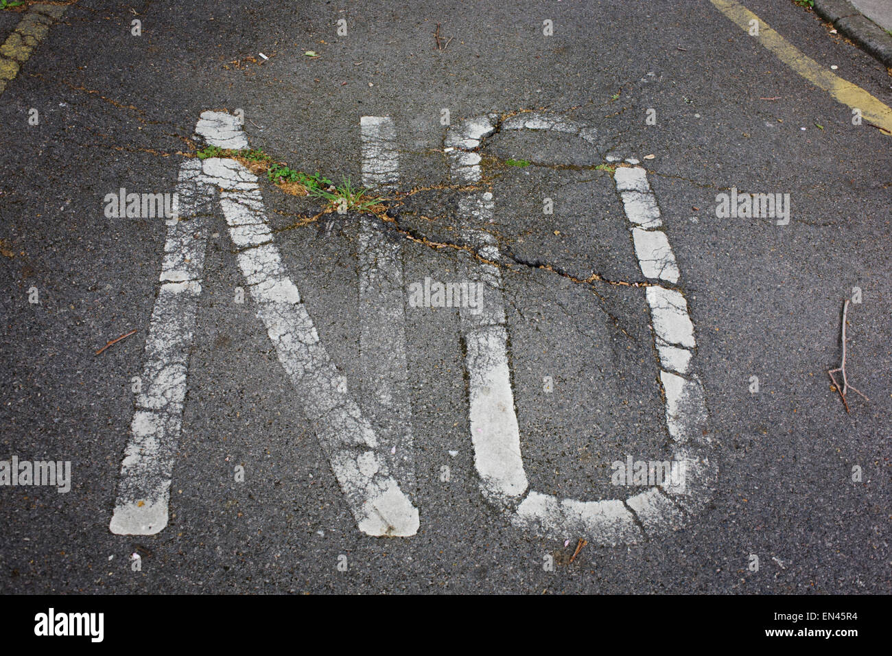 The word NO fading on a south London housing estate road surface Stock ...