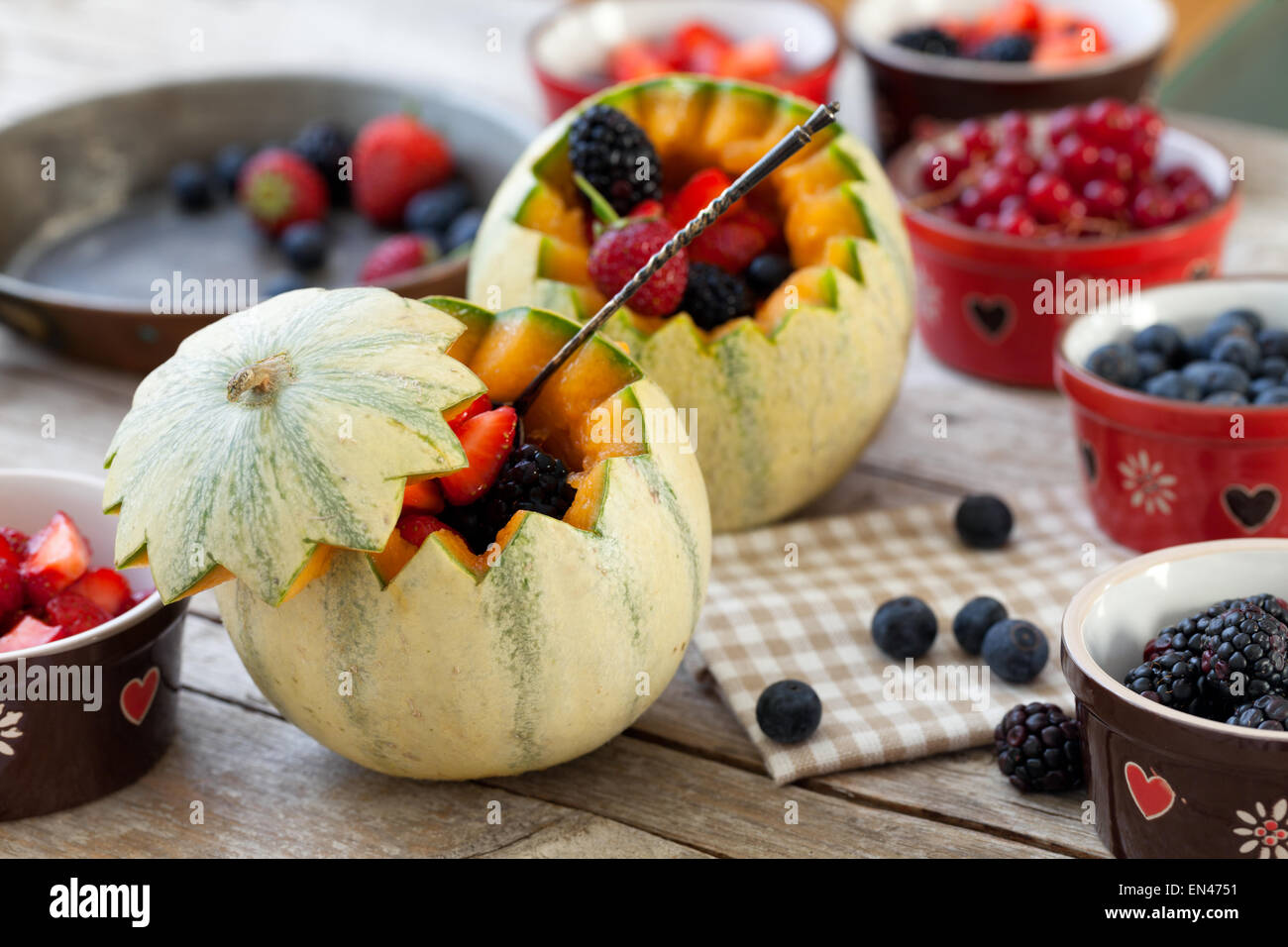 French Melons Filled With Berries Stock Photo - Alamy