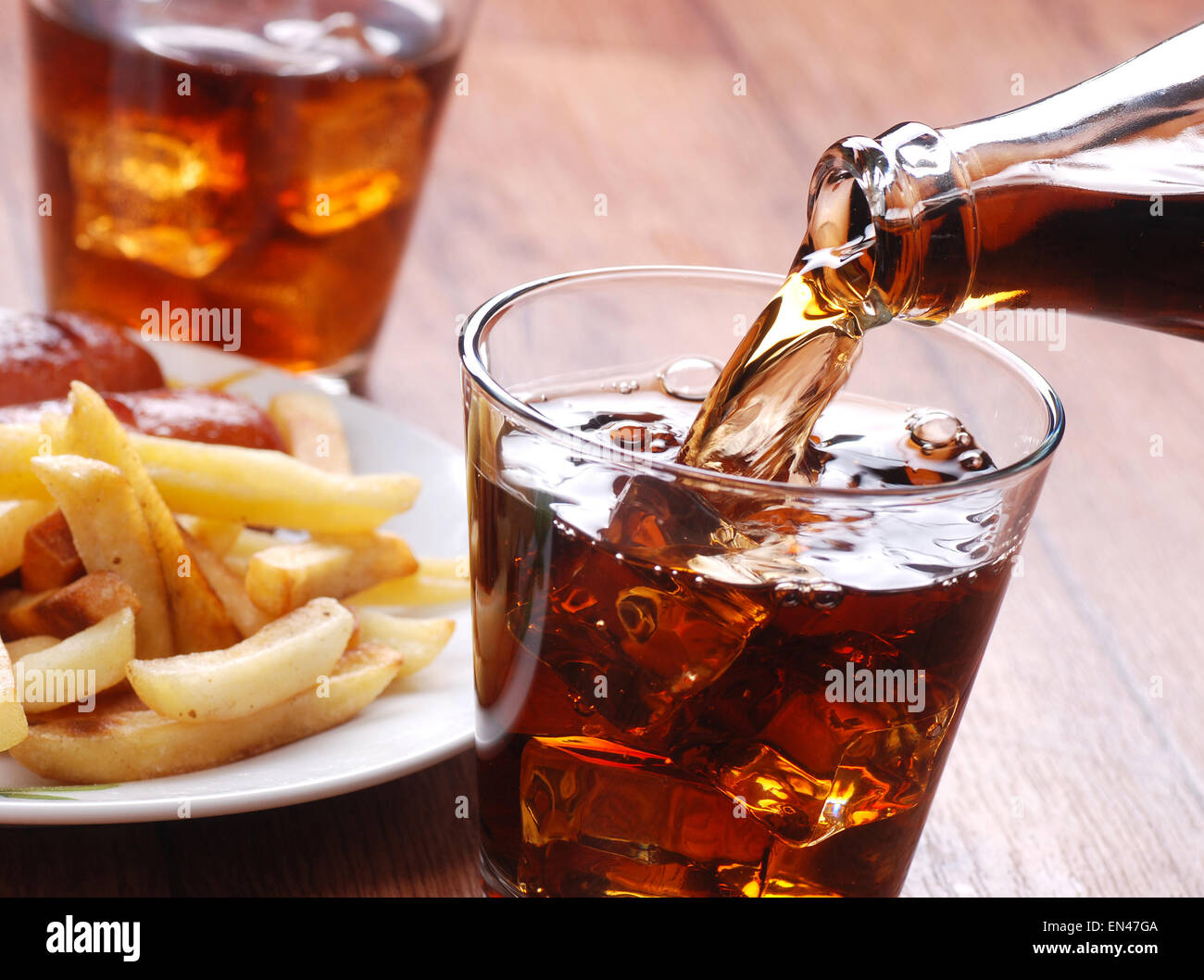 pouring cola in glass beaker Stock Photo - Alamy