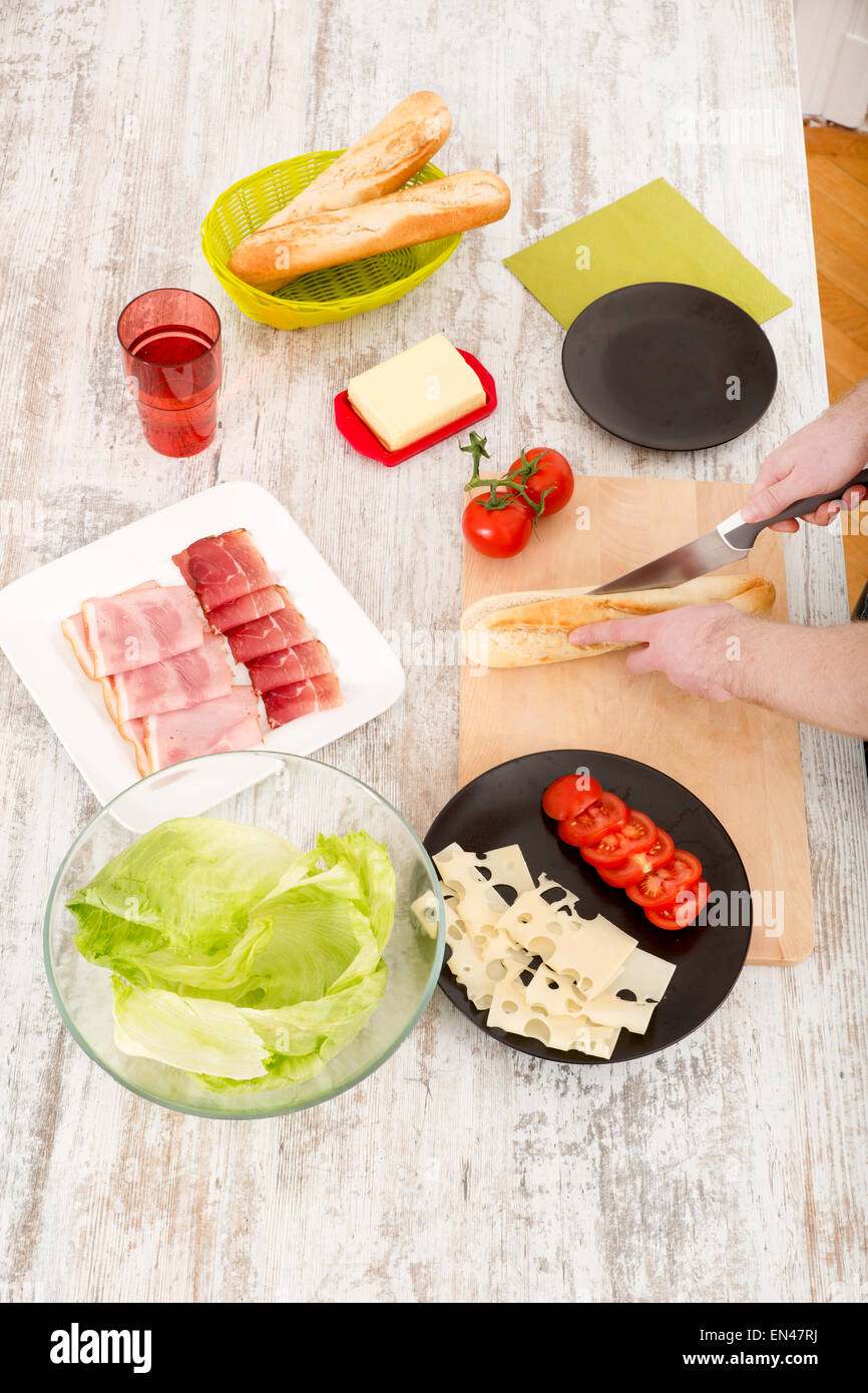 A young man preparing a sandwich in the kitchen Stock Photo - Alamy