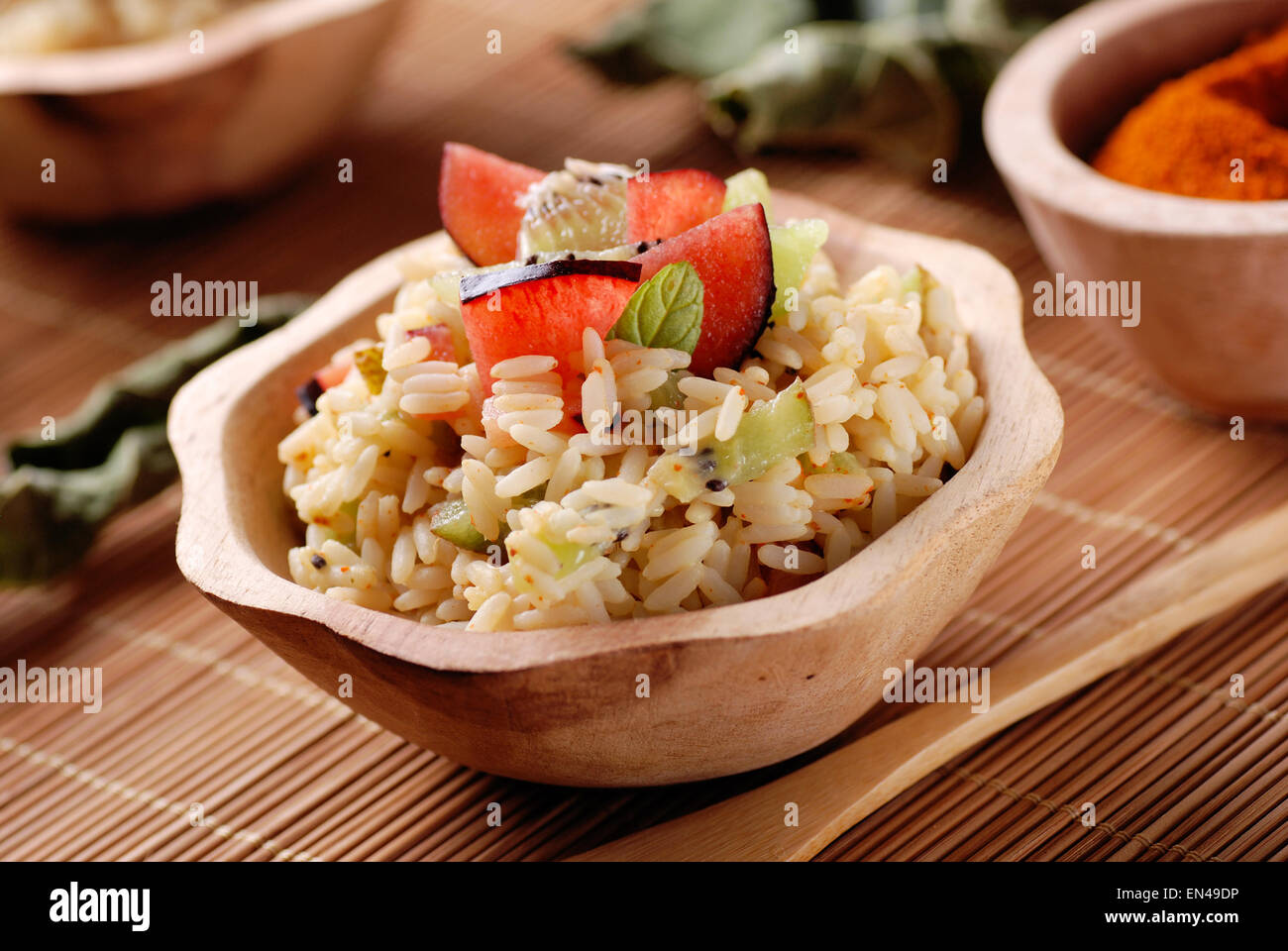 spiced rice with fruit in wooden bowl Stock Photo - Alamy