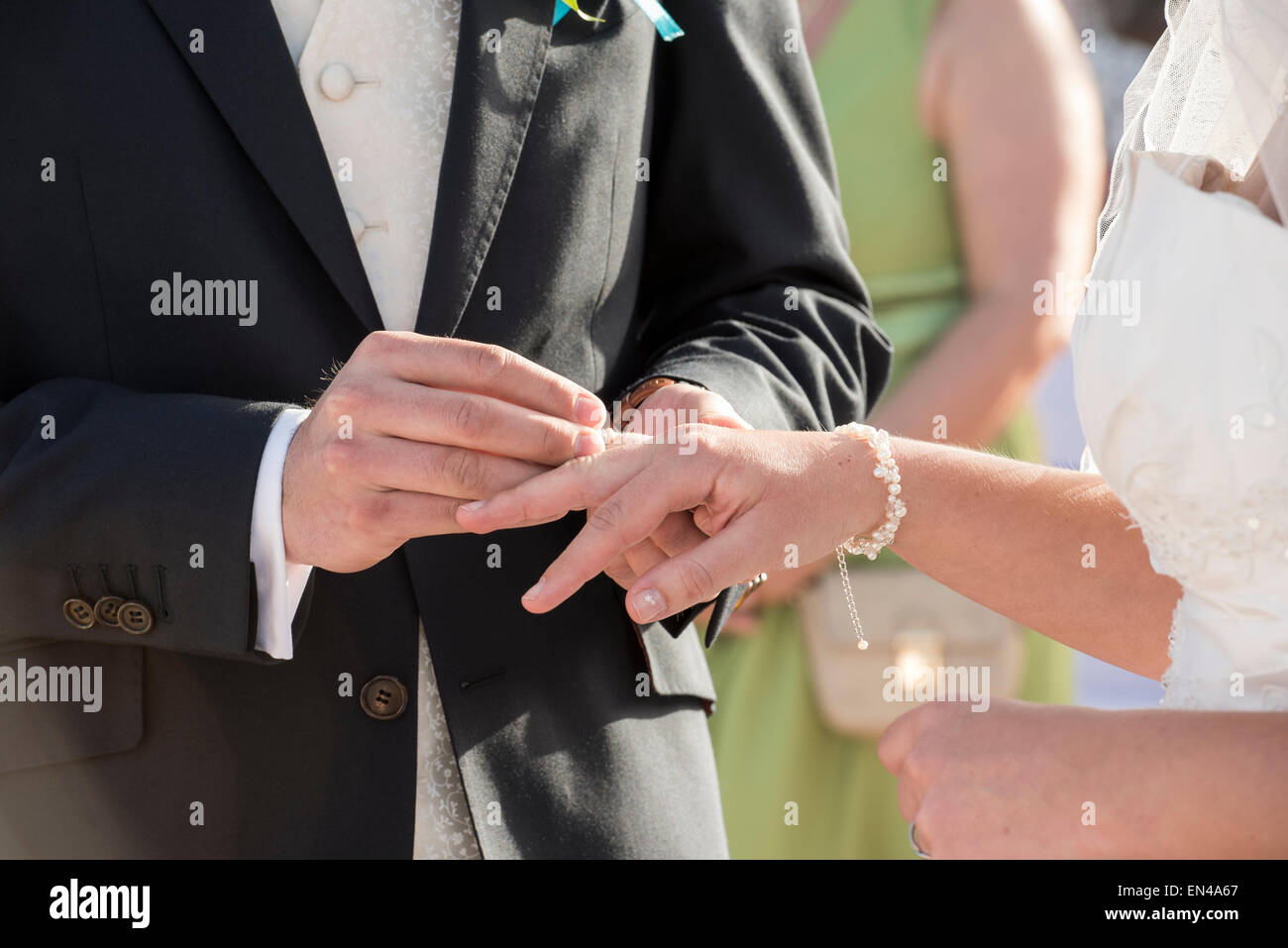 Groom putting wedding ring on a brides finger at wedding ceremony Stock ...