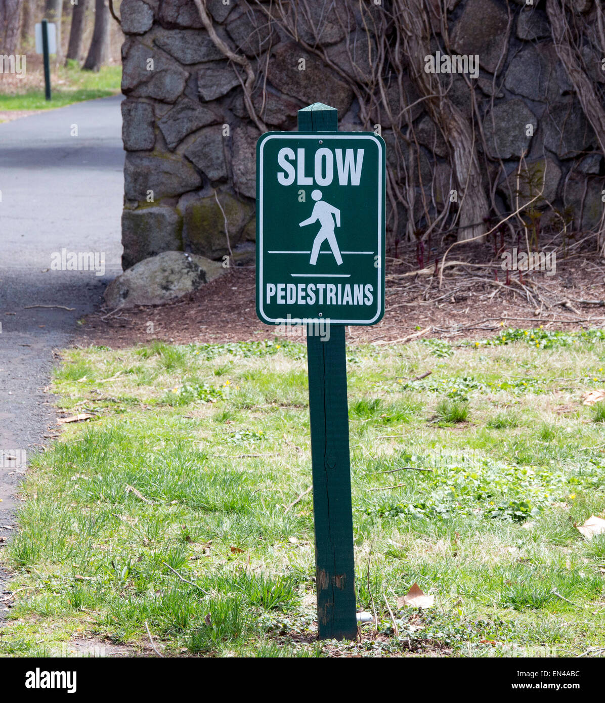Slow pedestrians warning sign on a post Stock Photo - Alamy