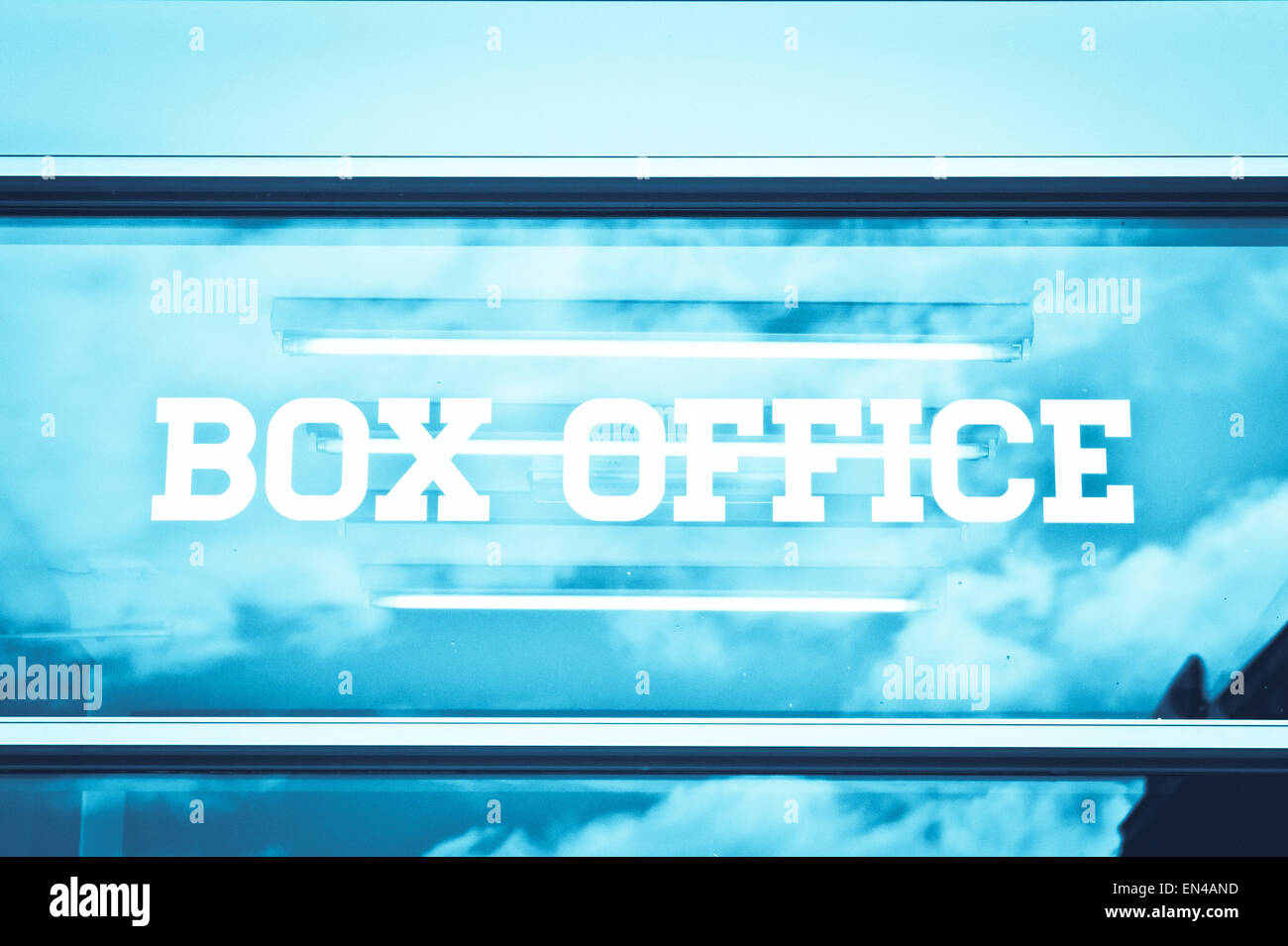Sign for a box office on a glass panel with reflections of the sky ...