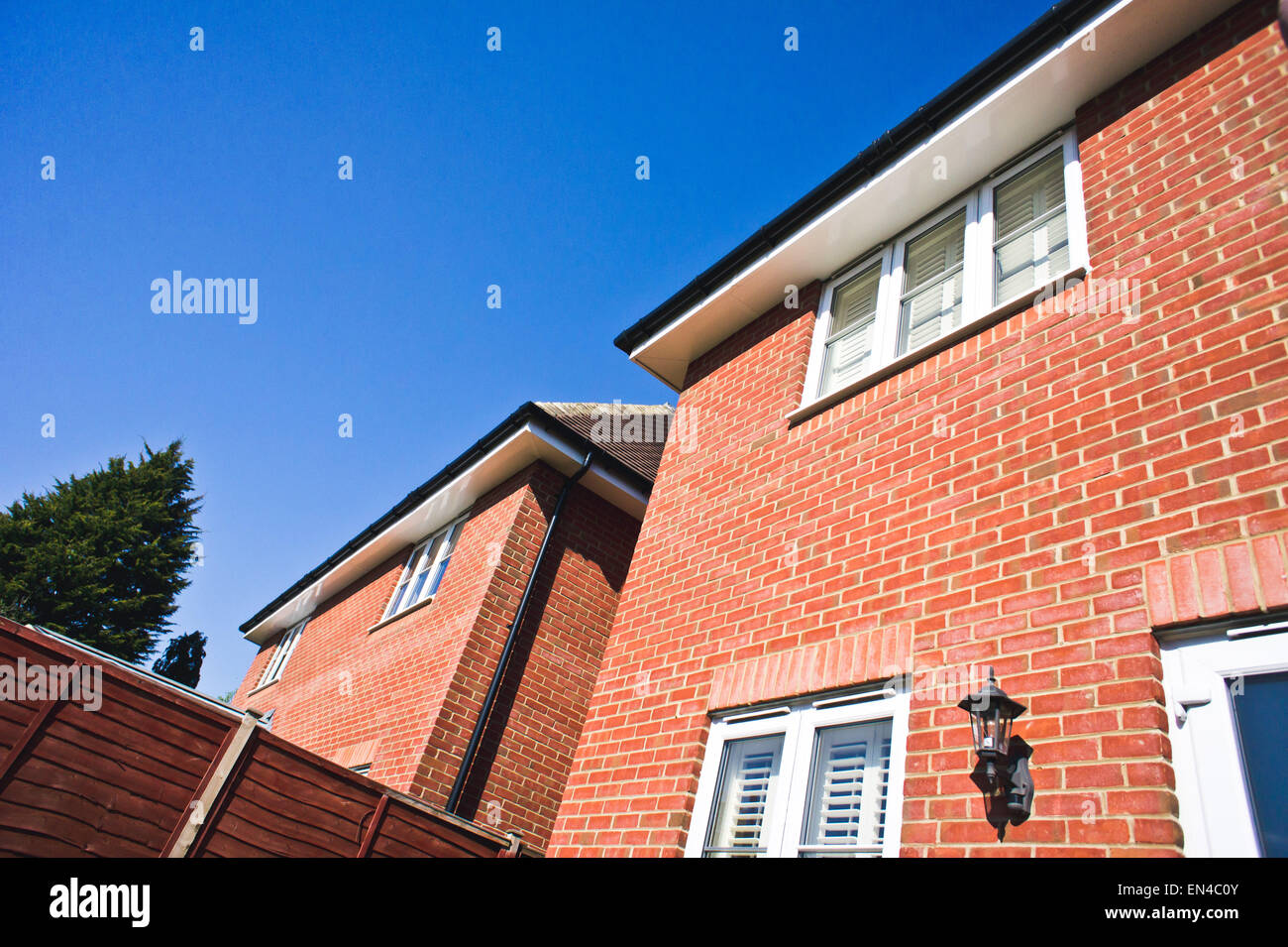 Adjacent detached modern houses in the UK on a sunny day Stock Photo ...