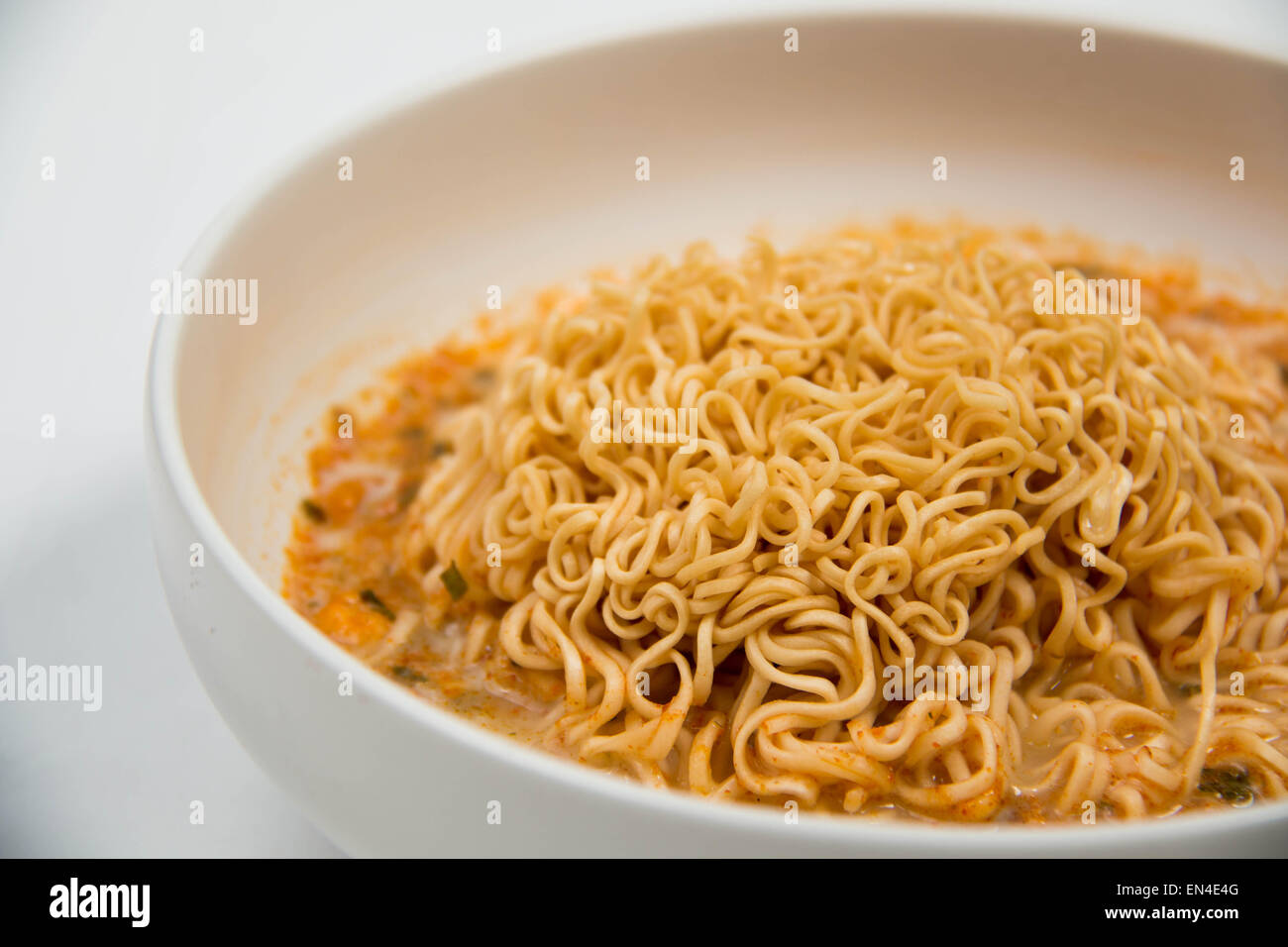 Instant noodles in dish on white background Stock Photo - Alamy