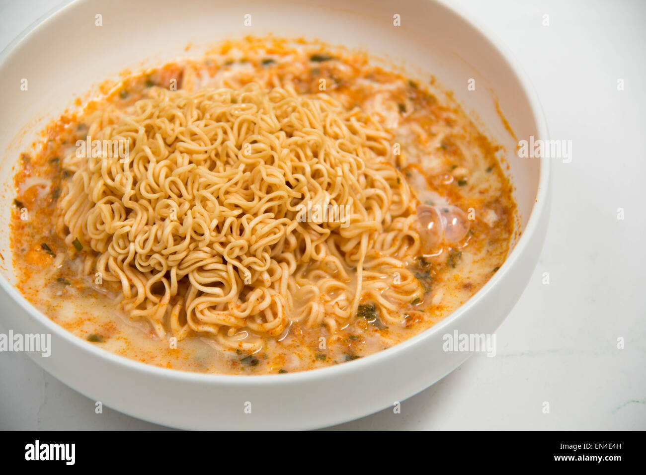 Instant noodles in dish on white background Stock Photo - Alamy