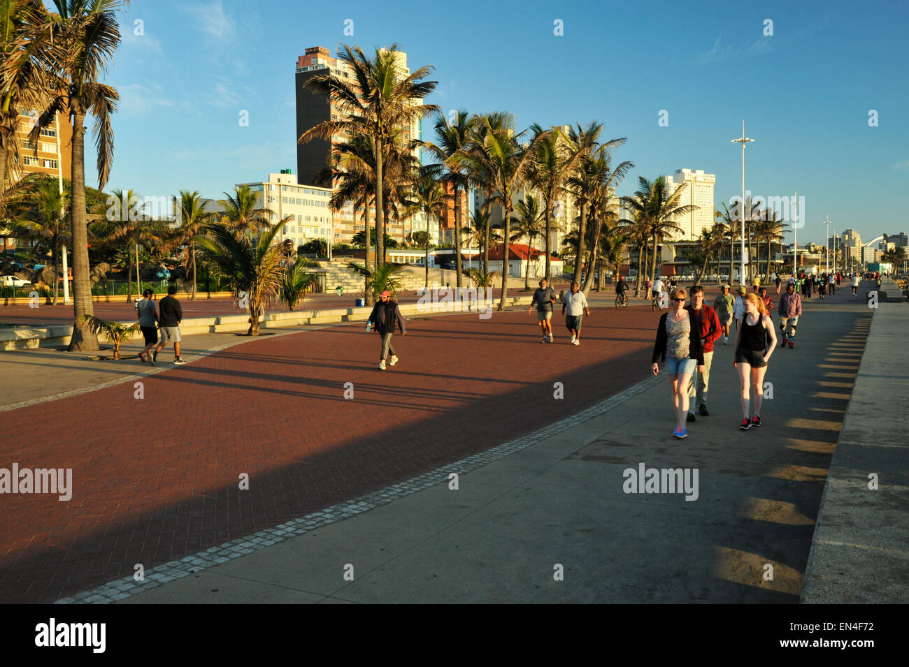 Groups of people walking on Durban beachfront promenade for exercise ...