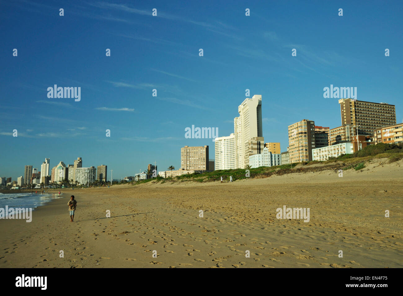 Skyline of Durban waterfront where adult man is taking an early morning ...