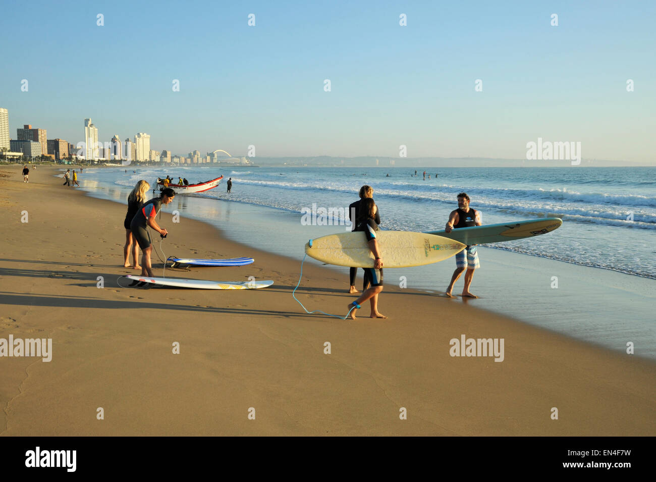Group of adult surfers with surfboards preparing to surf at iconic ...
