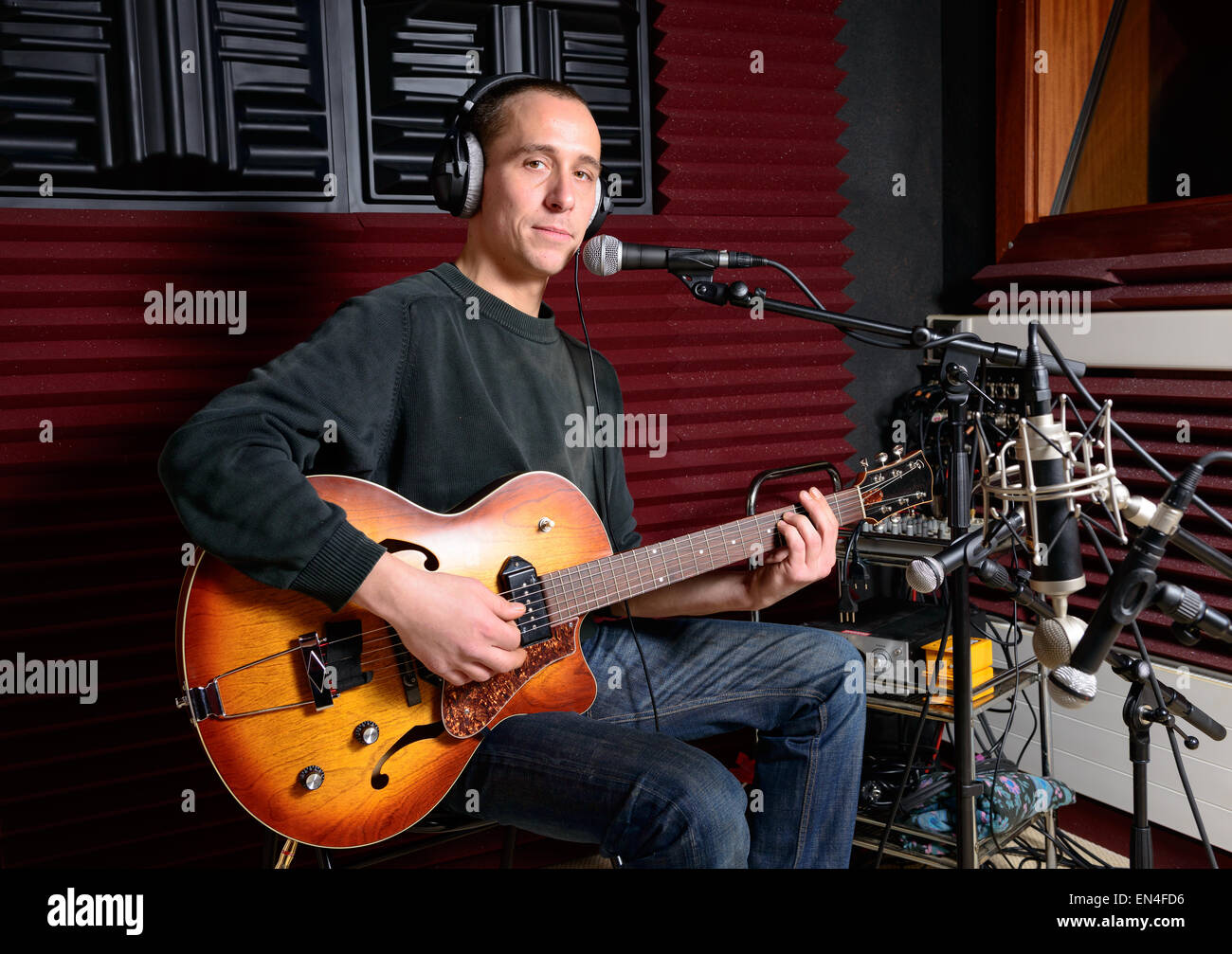 a singer and his guitar in a recording studio Stock Photo - Alamy