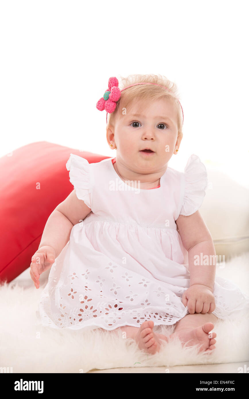 Beauty blond baby girl sitting on fluffy blanket Stock Photo - Alamy